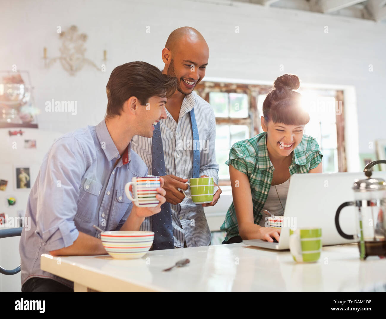 Friends using laptop together at breakfast Stock Photo - Alamy