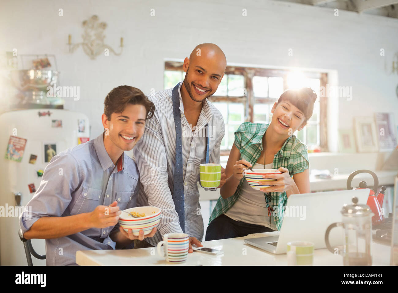 Friends having breakfast together in kitchen Stock Photo - Alamy