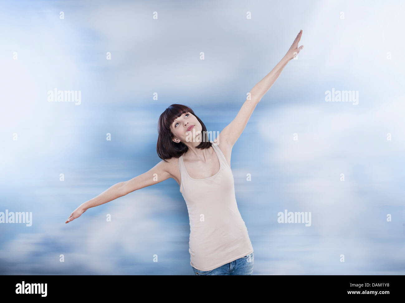 Germany, Cologne, Young woman with arm outstretched Stock Photo - Alamy