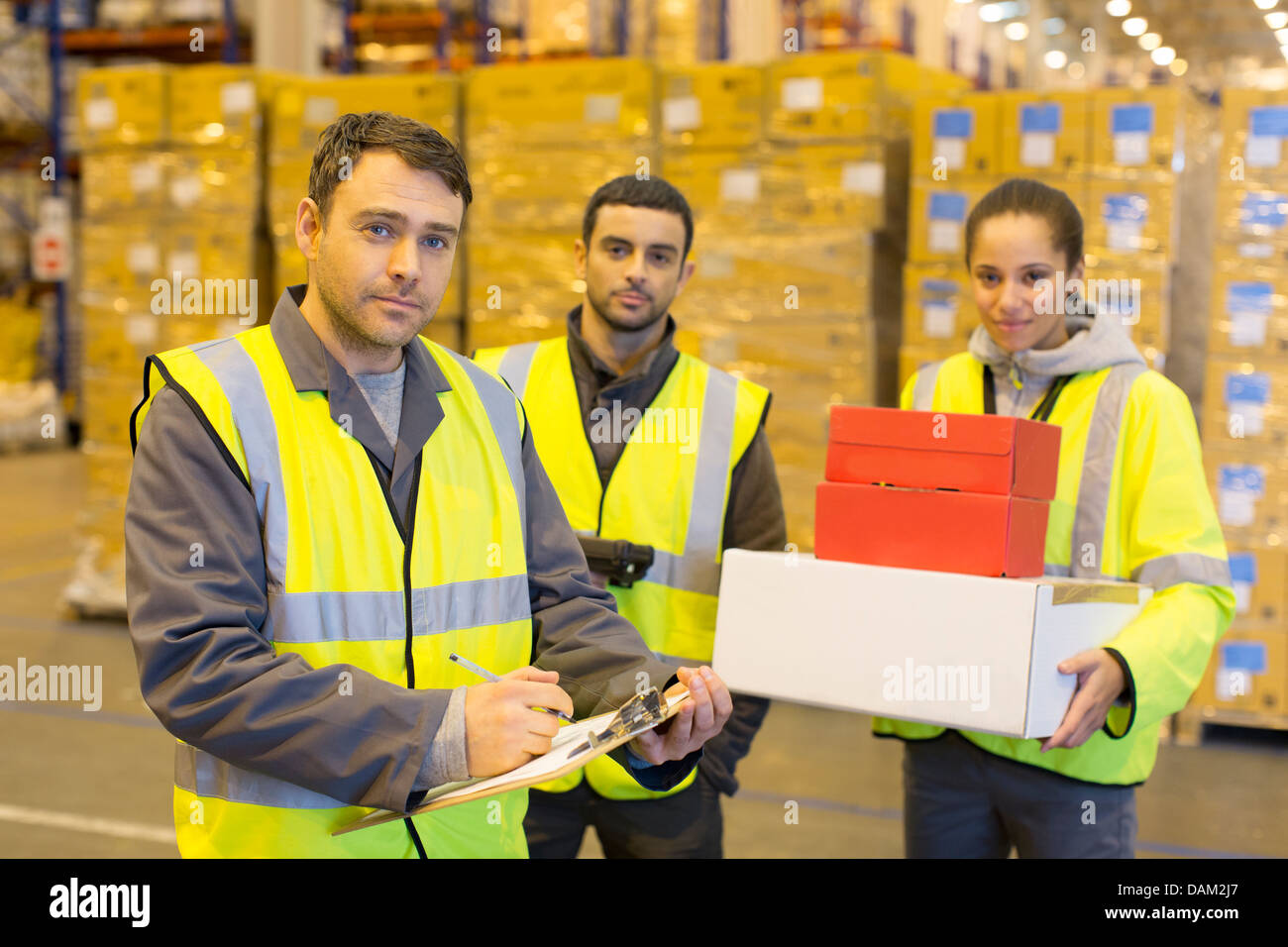 Workers standing in warehouse Stock Photo - Alamy