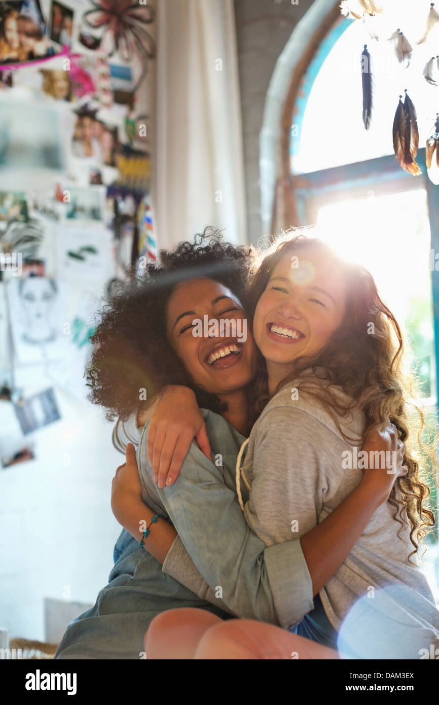 Back view three women hugging hi-res stock photography and images - Alamy