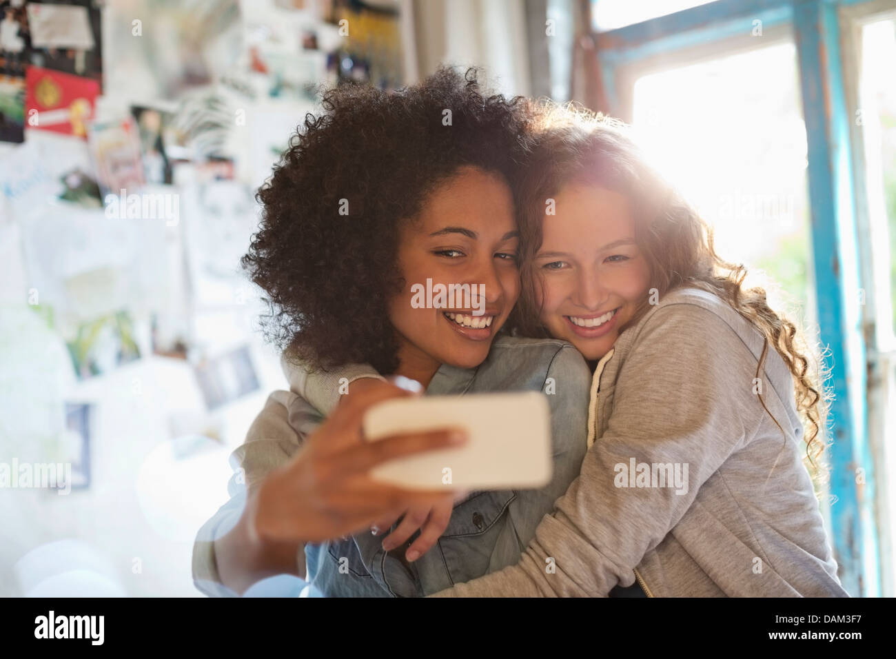 Women taking picture together in bedroom Stock Photo - Alamy