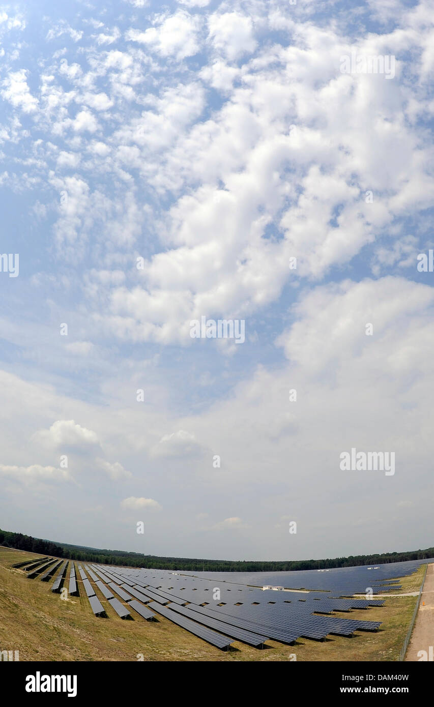 The sun shines in a blue sky above a solar park run by the company ...