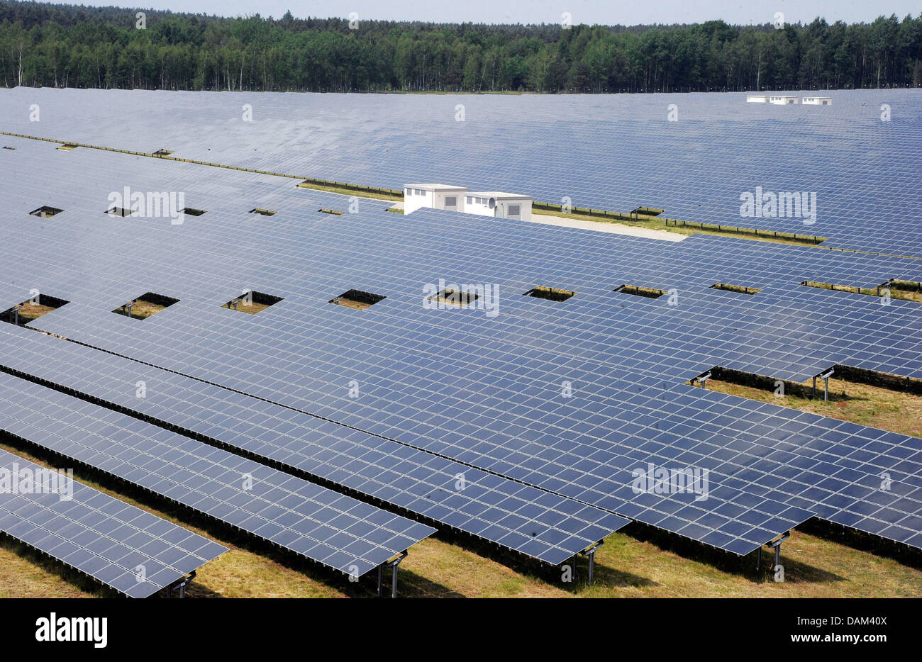 The sun shines in a blue sky above a solar park run by the company ...