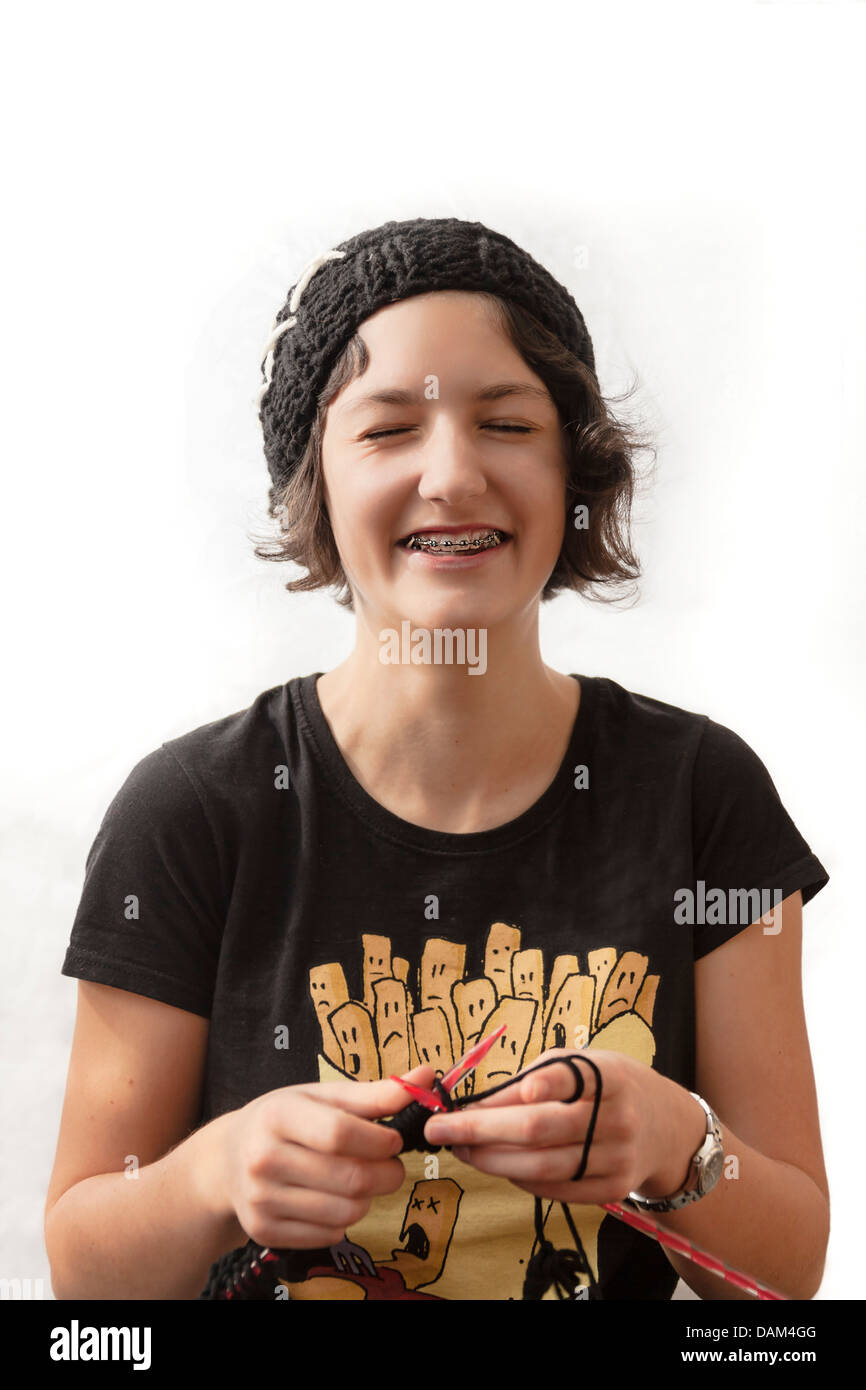 Teenage girl knitting wool against white background Stock Photo - Alamy