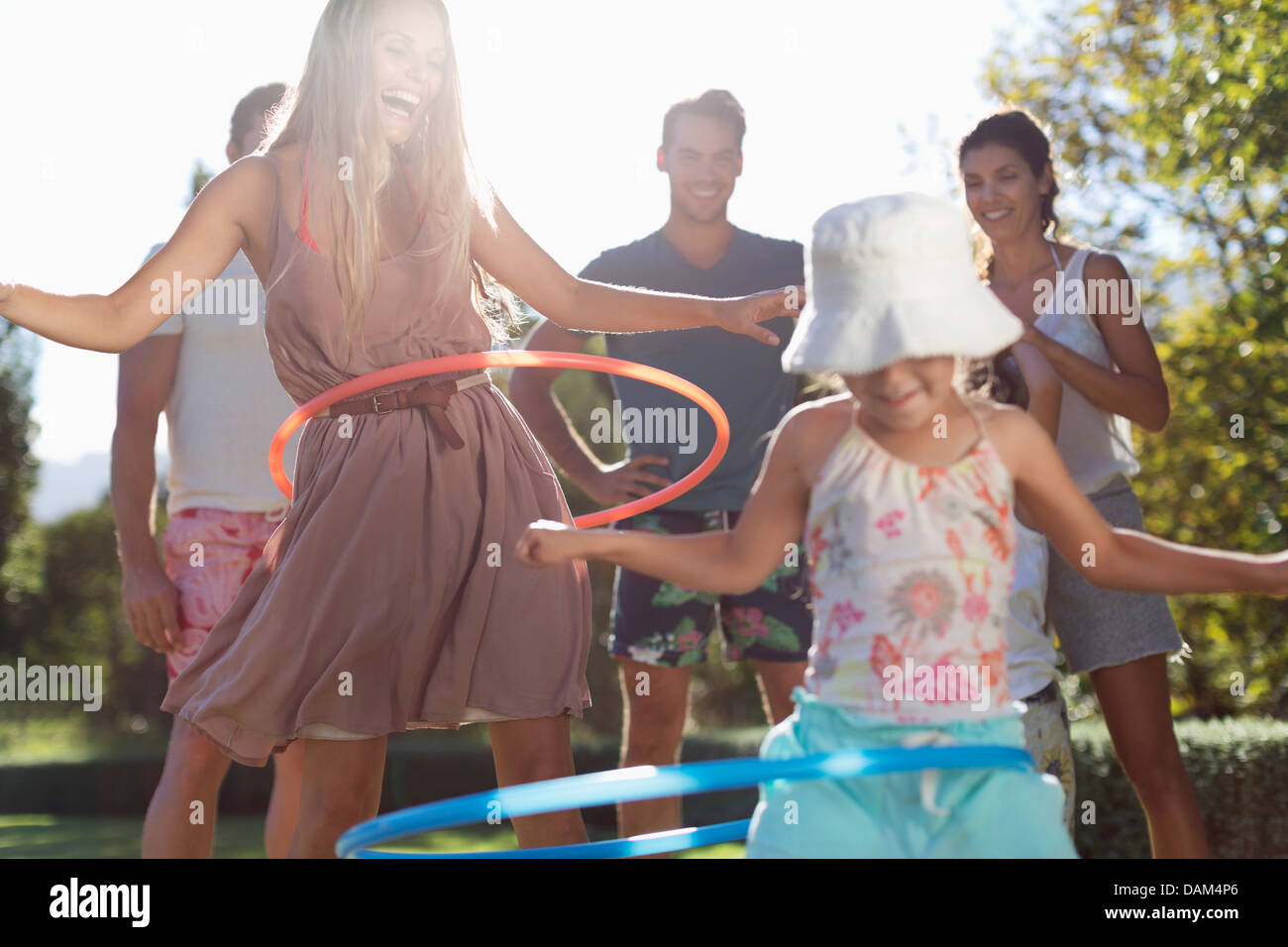 Girls hula hooping in backyard Stock Photo - Alamy