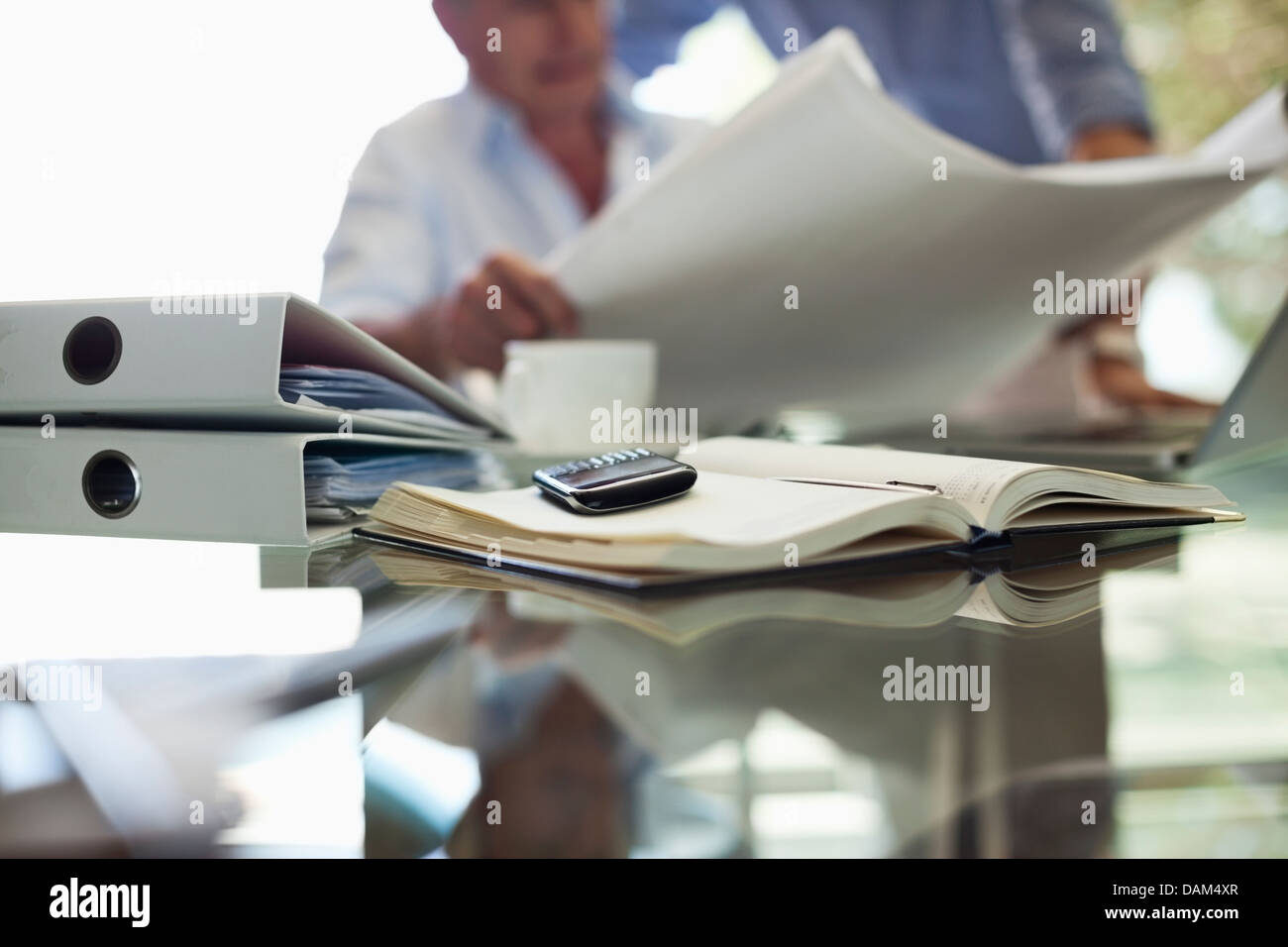 Cell phone on businessman's desk Stock Photo - Alamy