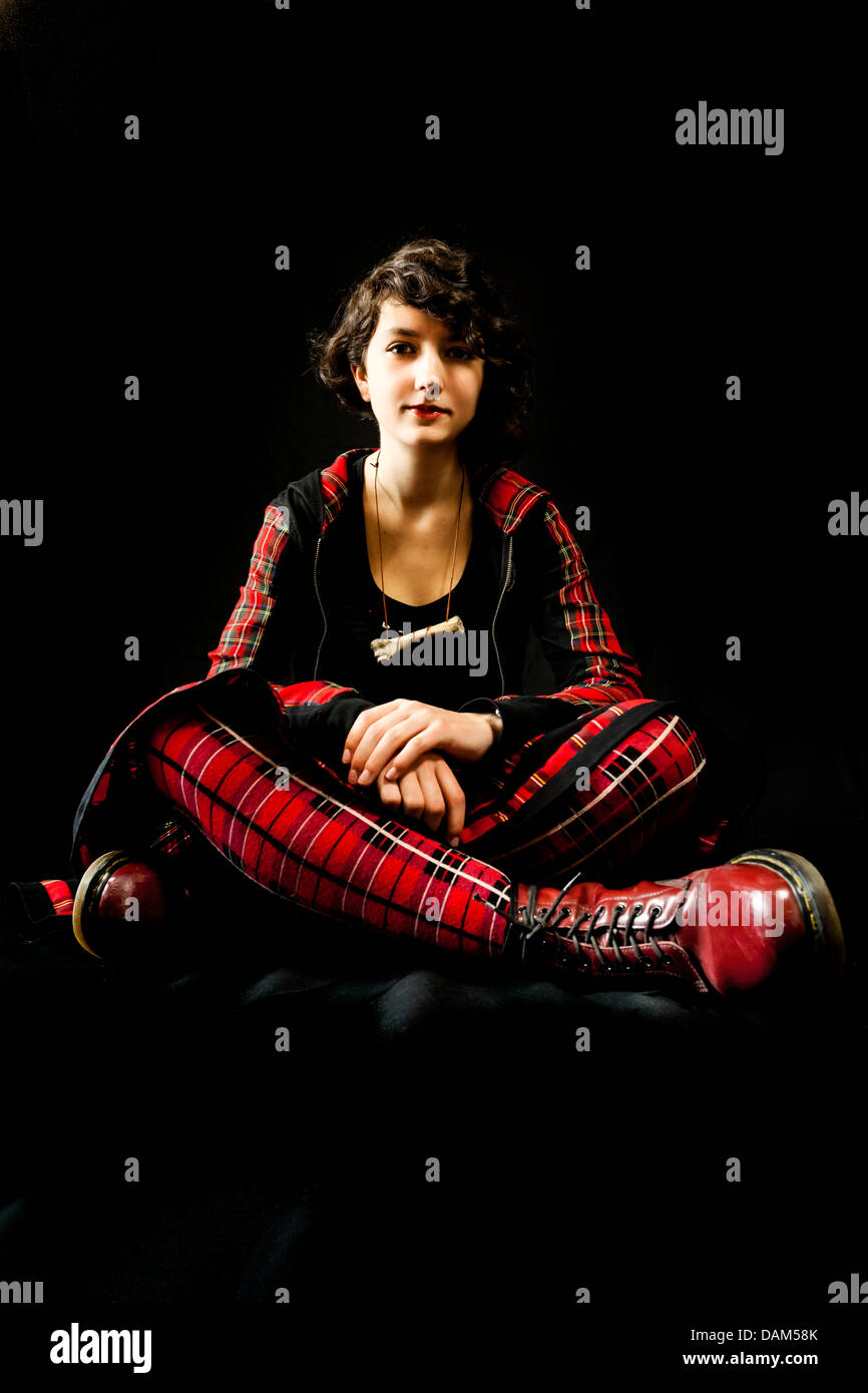 Portrait of teenage girl against black background Stock Photo - Alamy