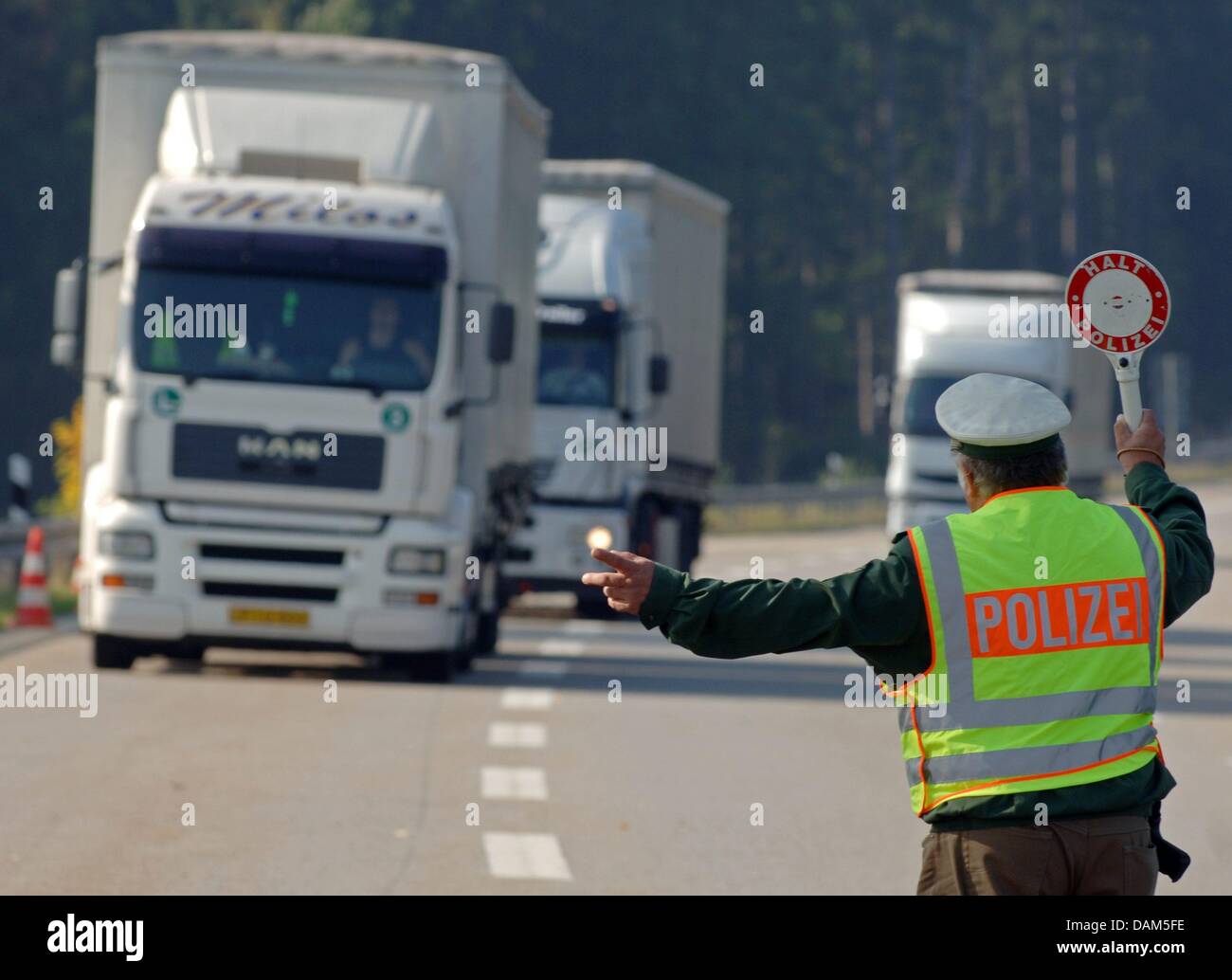 Police officer waving hi-res stock photography and images - Alamy