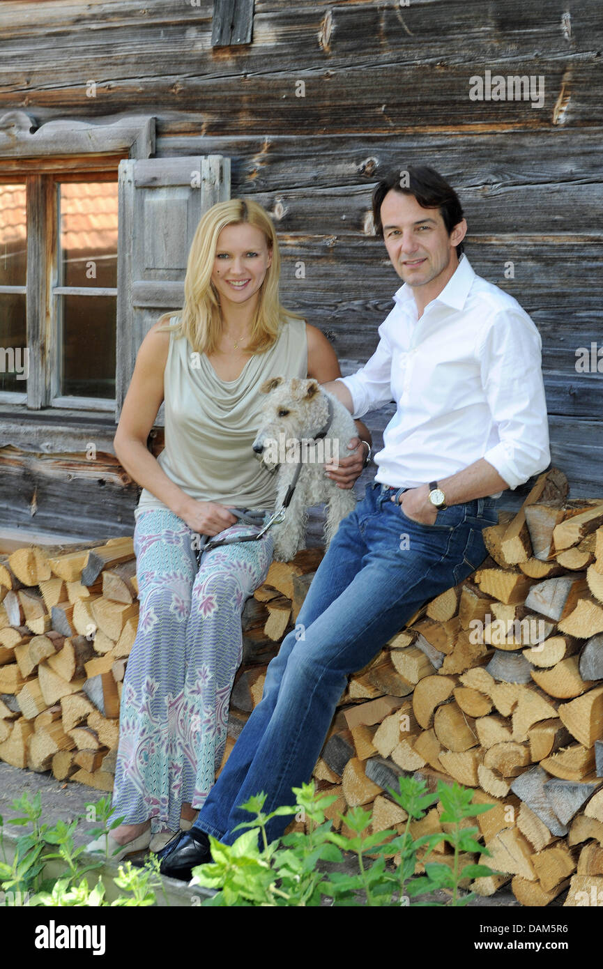 Actors Veronica Ferres (L) and Hans-Werner Meyer pose with a dog at the ...
