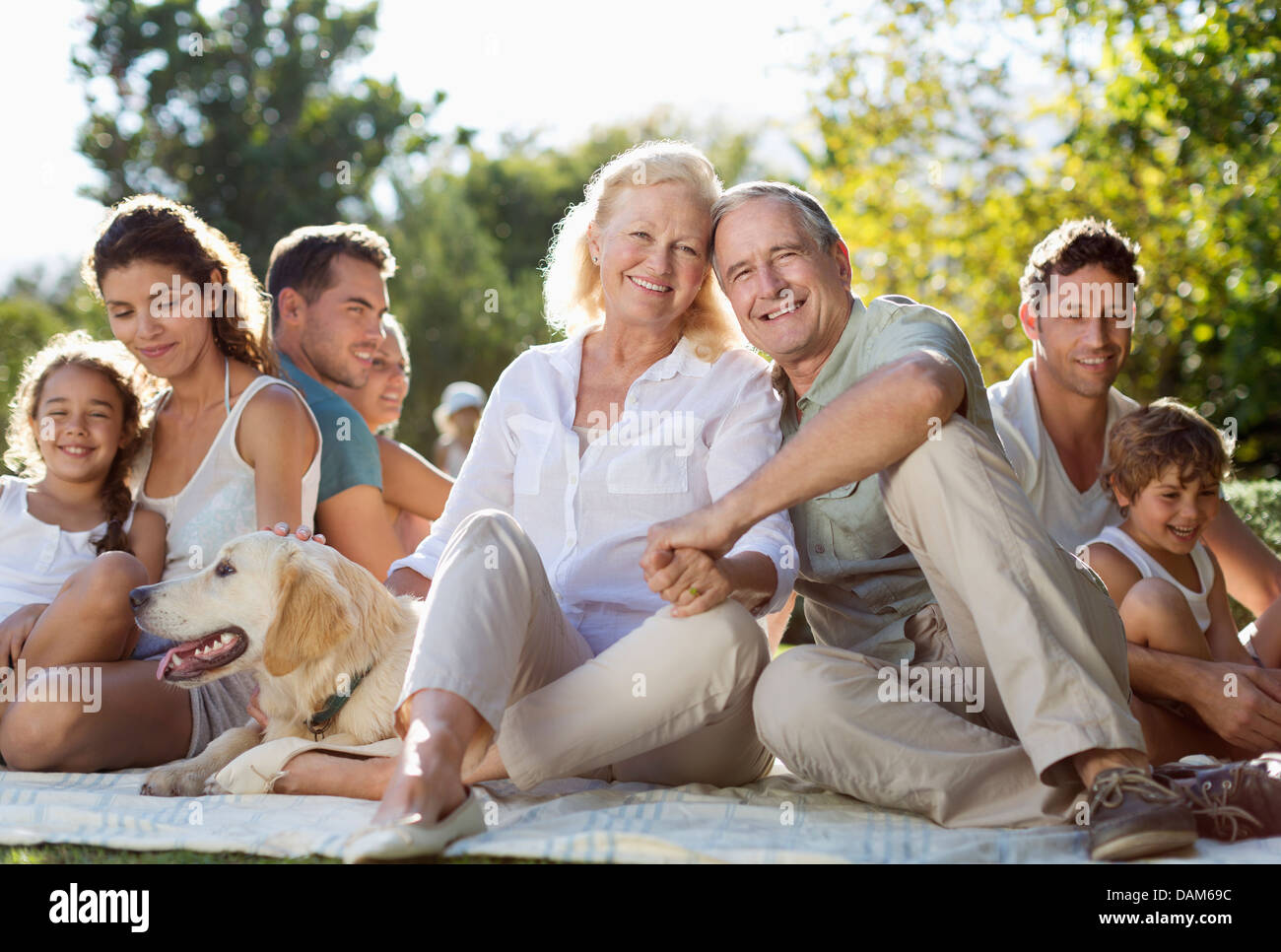 Family relaxing together in backyard Stock Photo - Alamy