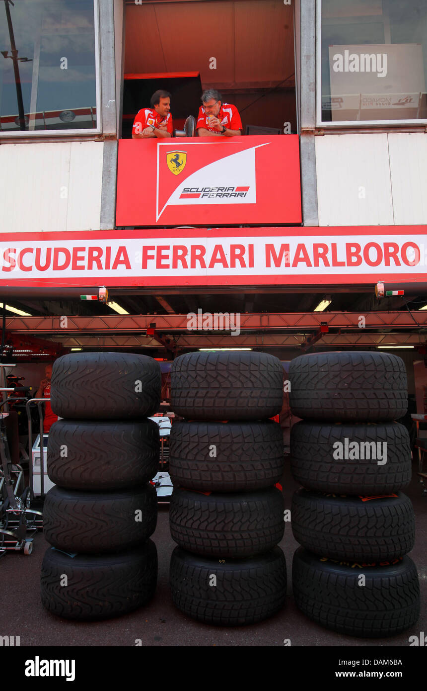Mechanics of Ferrari look out of a window of the teamgarage at the F1 ...