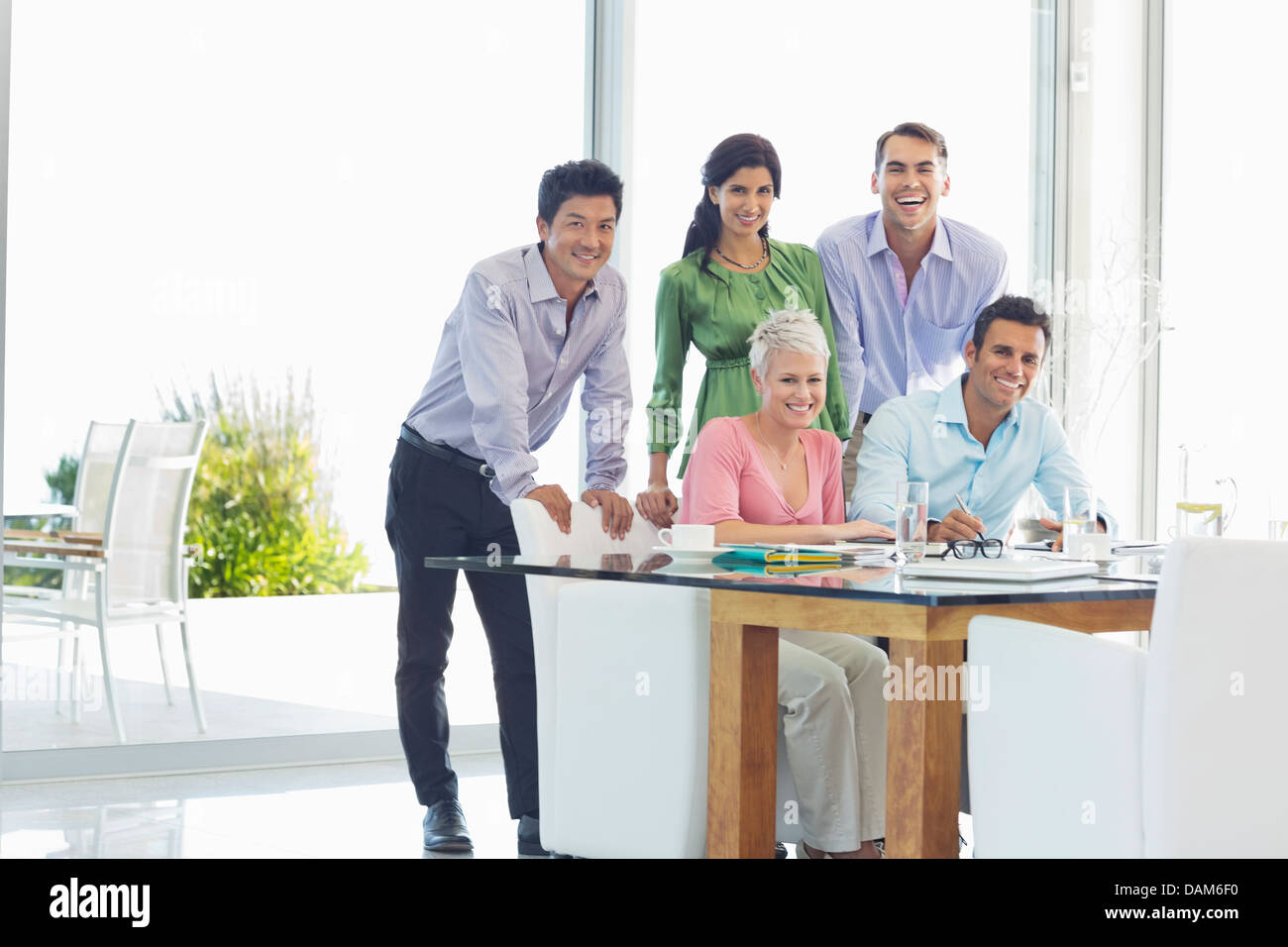 Business people smiling together in office Stock Photo - Alamy