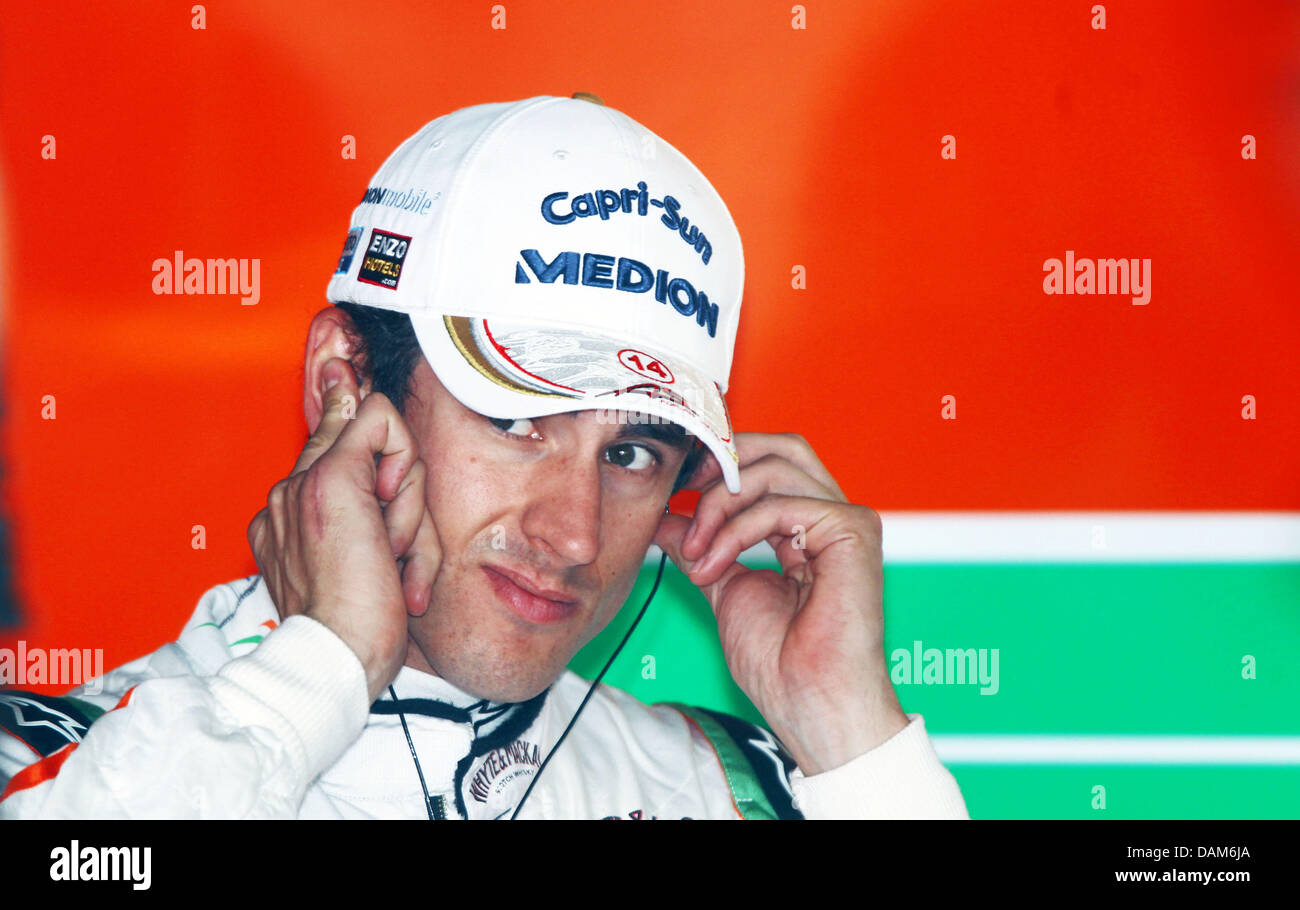 German Formula One driver Adrian Sutil of Force India adjusts his ...
