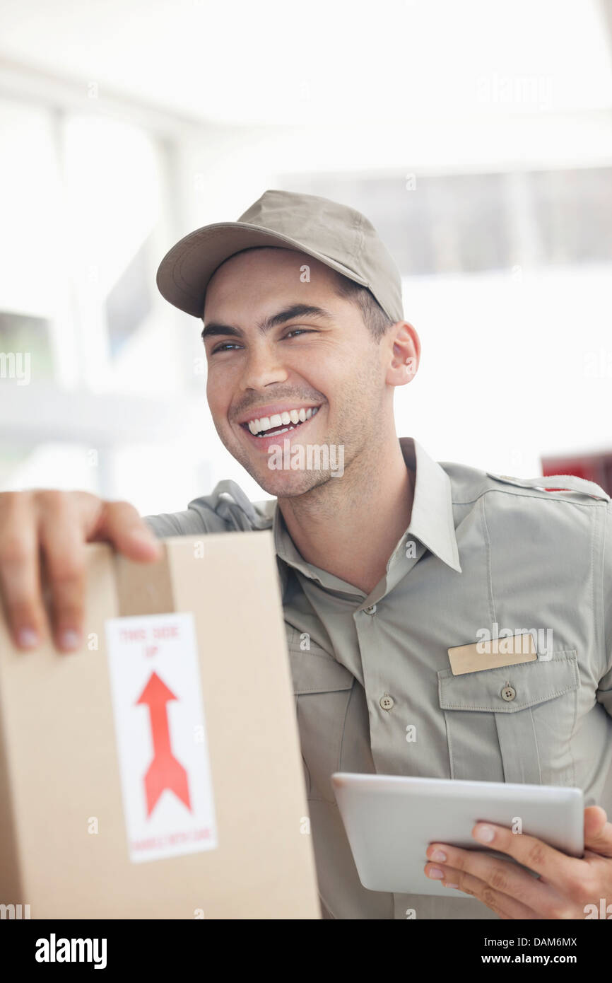 Delivery boy using tablet computer Stock Photo - Alamy