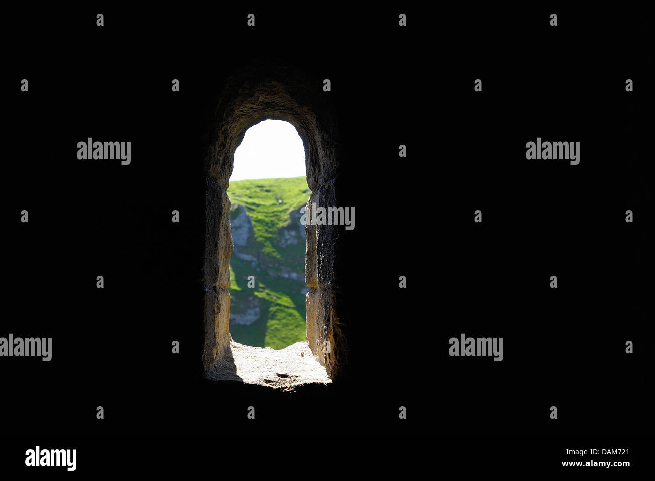 Narrow castle window with daylight shining through England uk Stock ...
