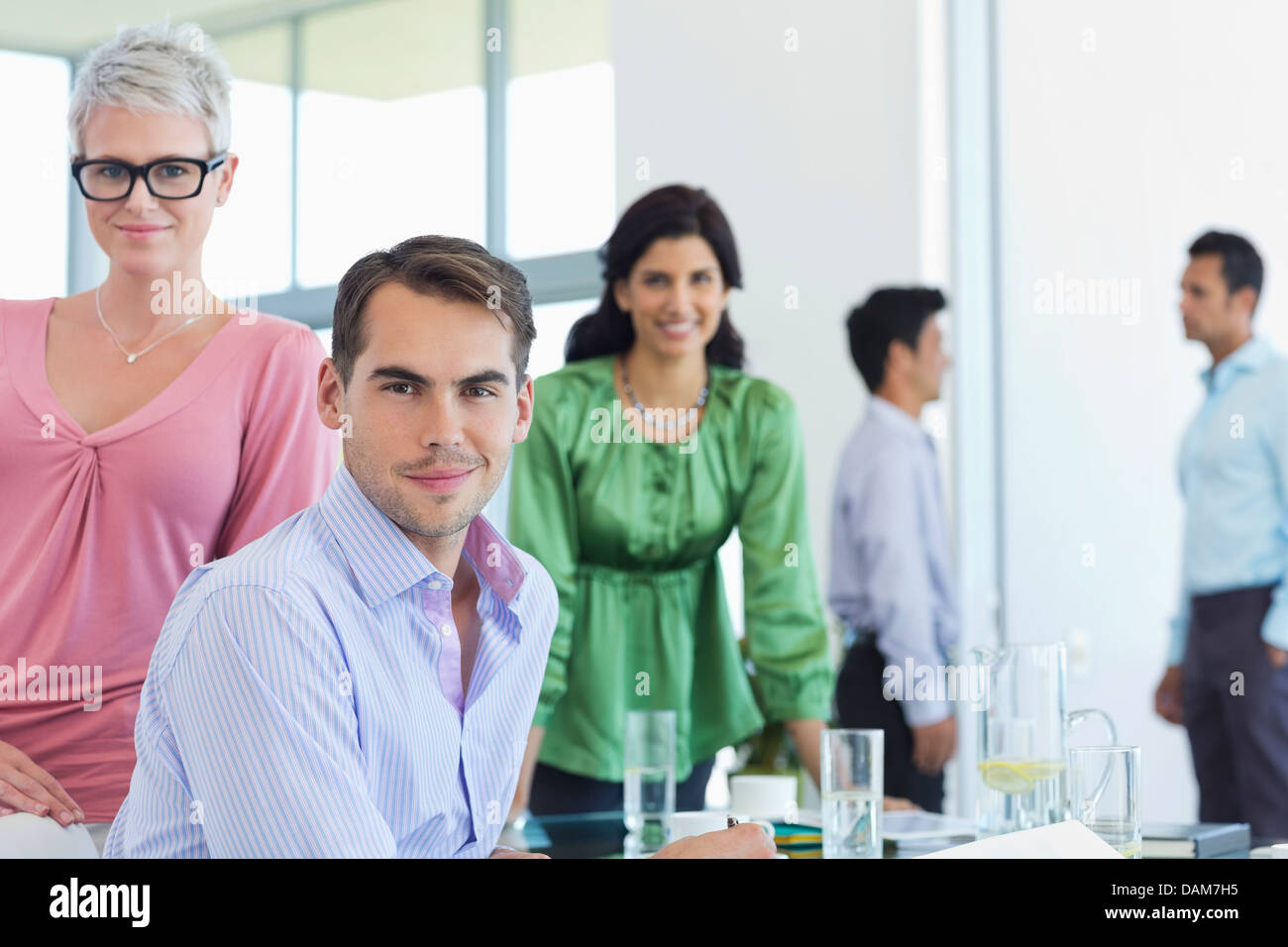 Business people smiling in office Stock Photo - Alamy