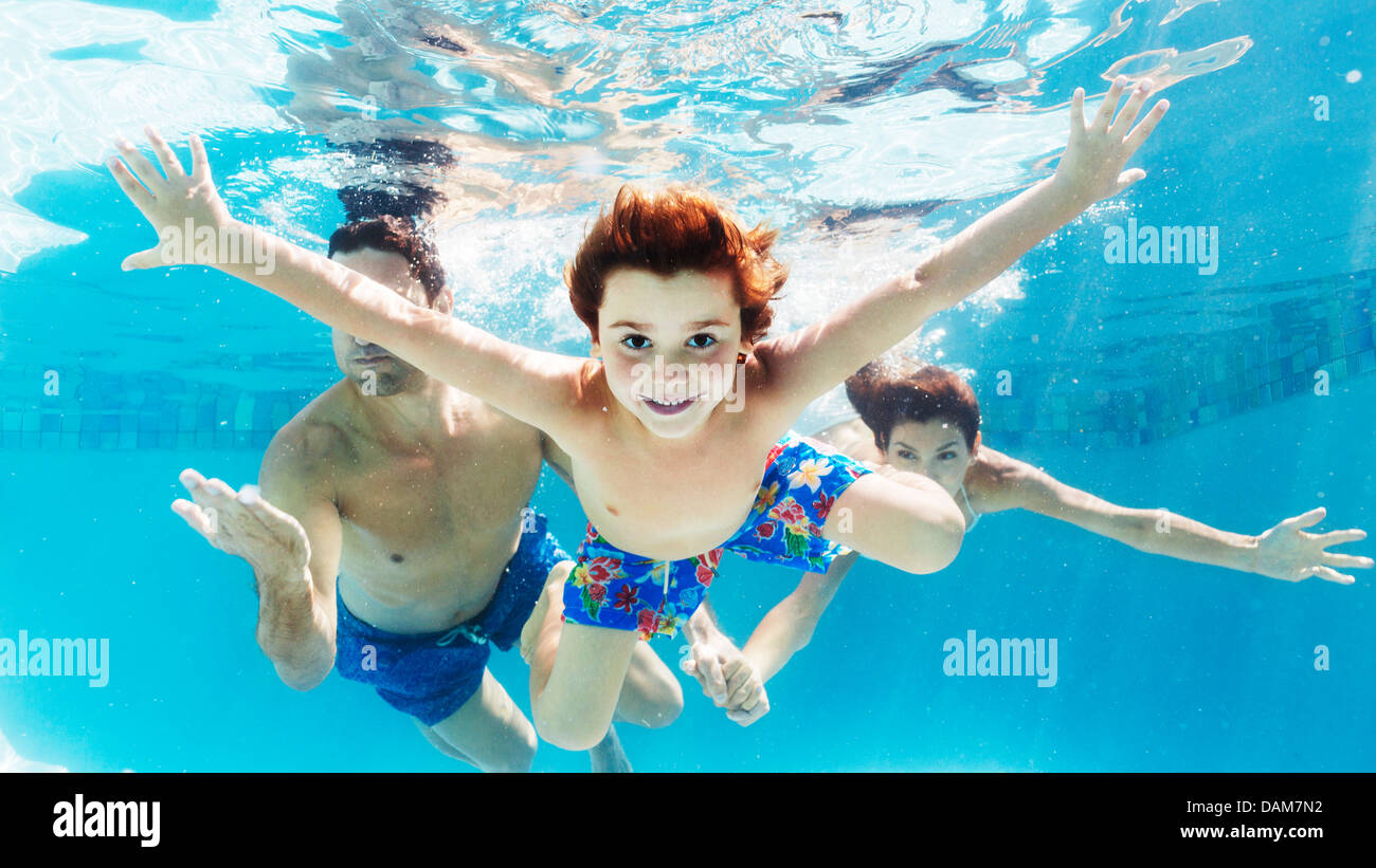 Family swimming in pool Stock Photo - Alamy