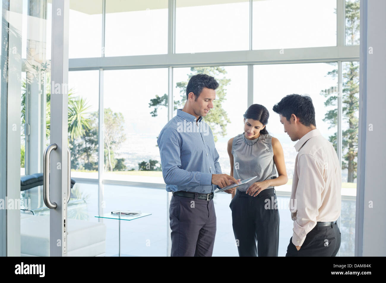 Business people using tablet computer in office Stock Photo - Alamy