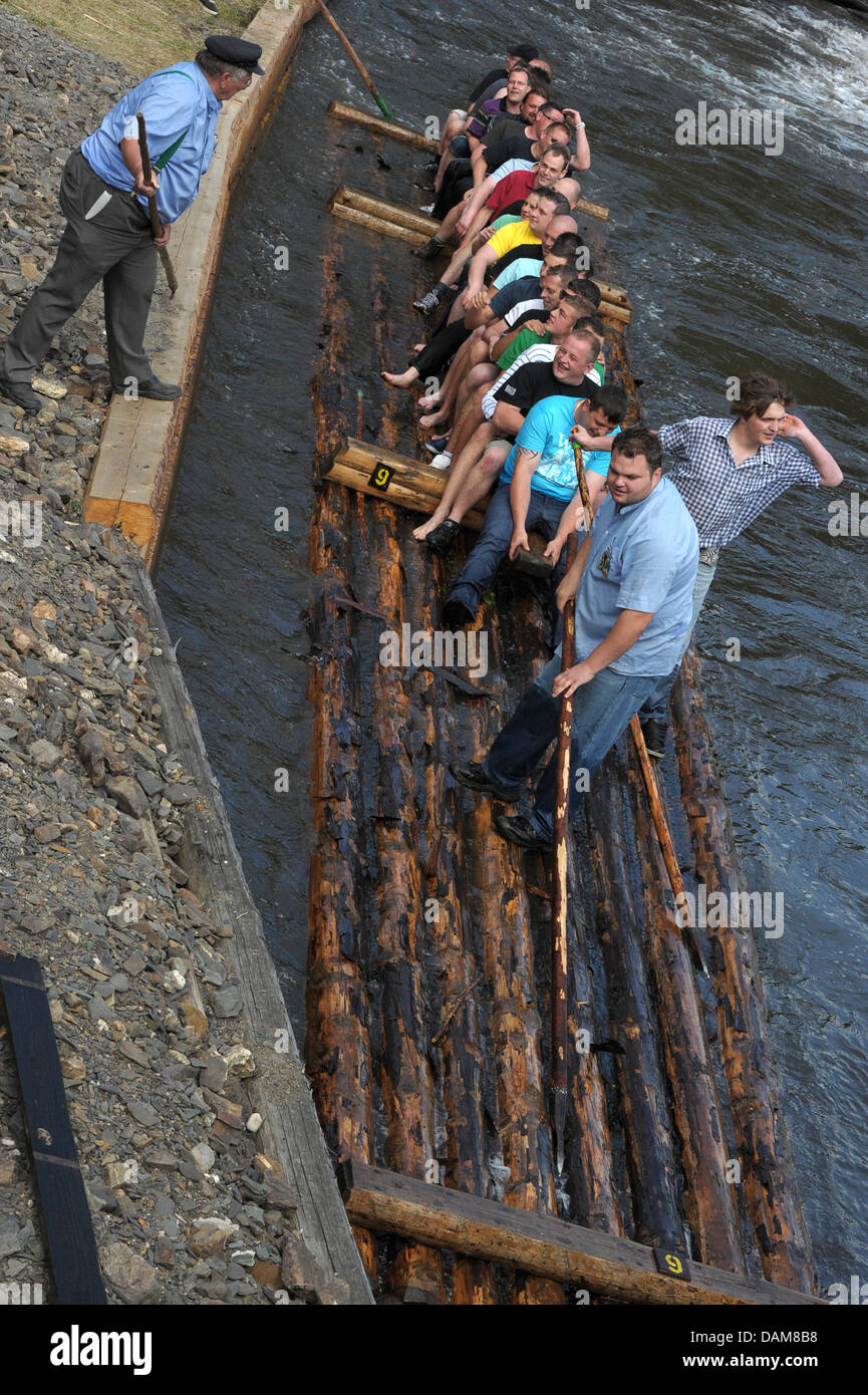 Two timber rafters guide their raft full of people on the wild Rodach ...