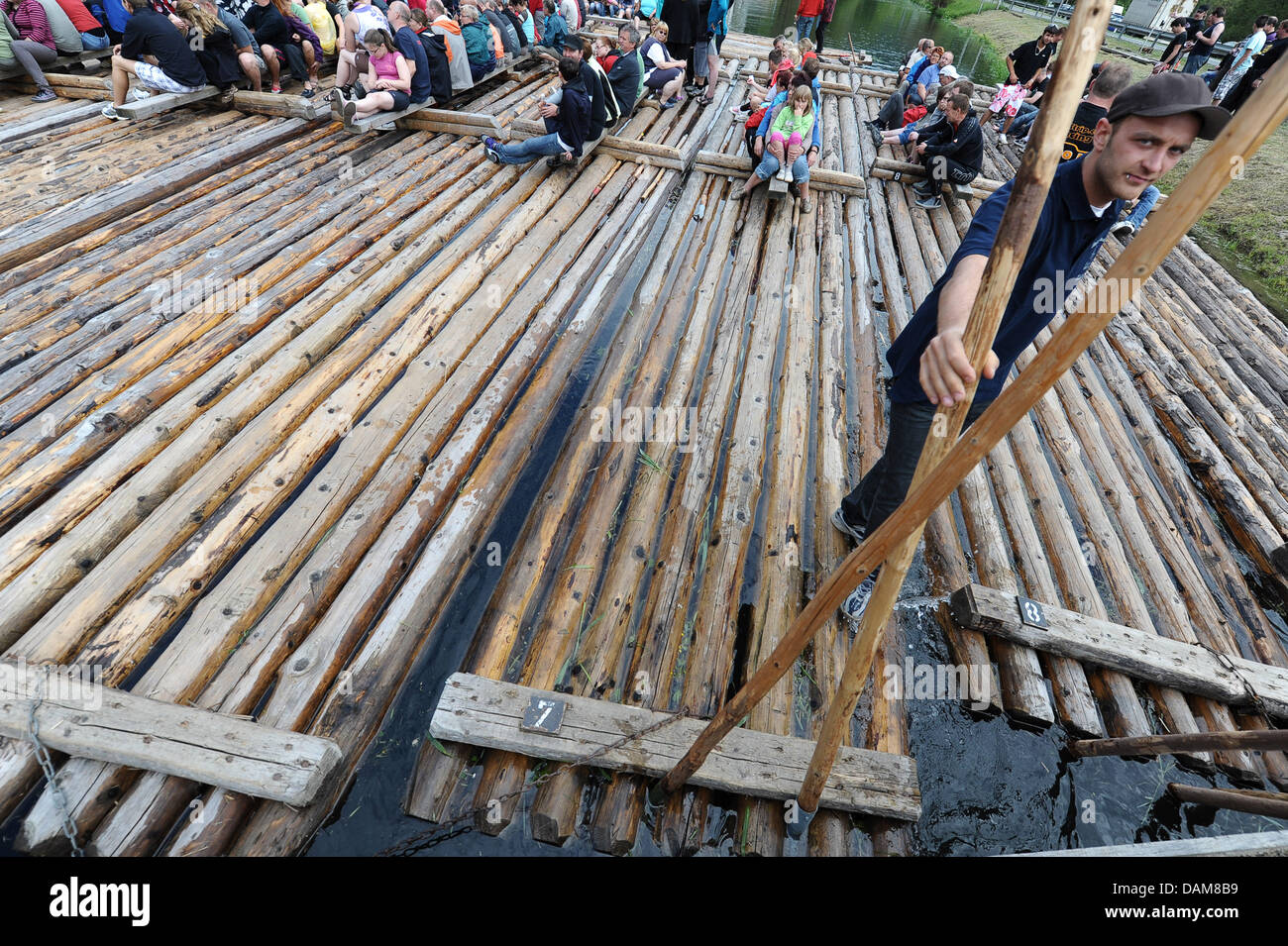 A timber rafter stands on his raft on the wild Rodach River in ...