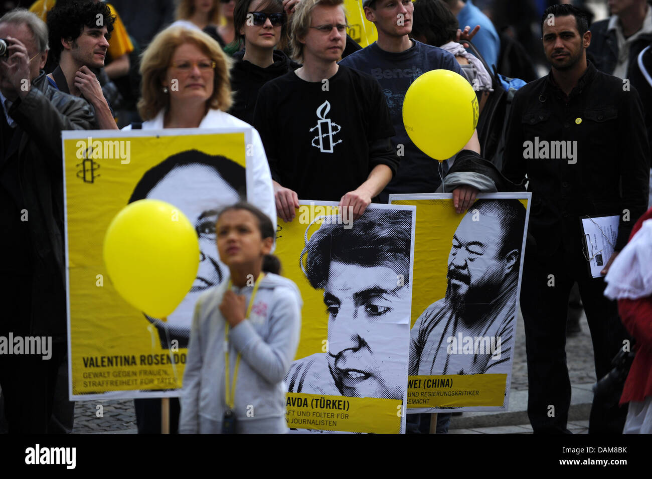 People with pictures of victims of human rights violations stand on ...