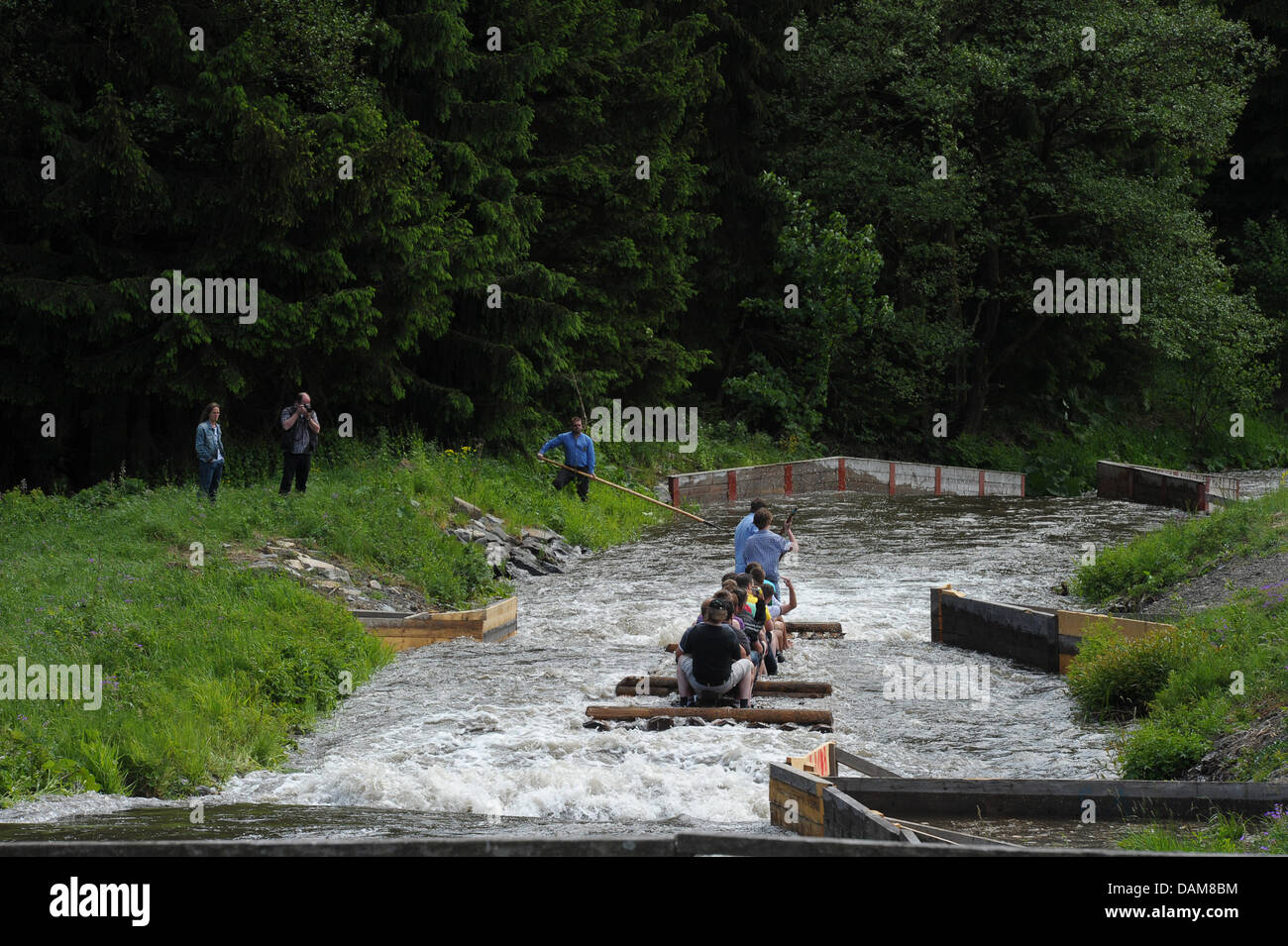 Two timber rafters guide their raft full of people on the wild Rodach ...