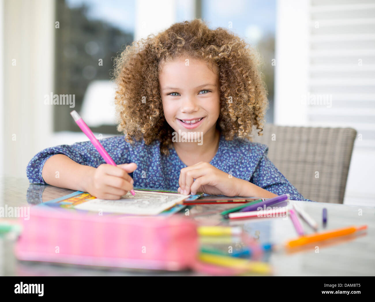 Girl coloring at table Stock Photo - Alamy