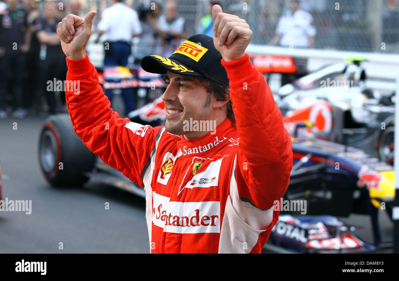 Spanish Formula One driver Fernando Alonso celebrates in front of the ...