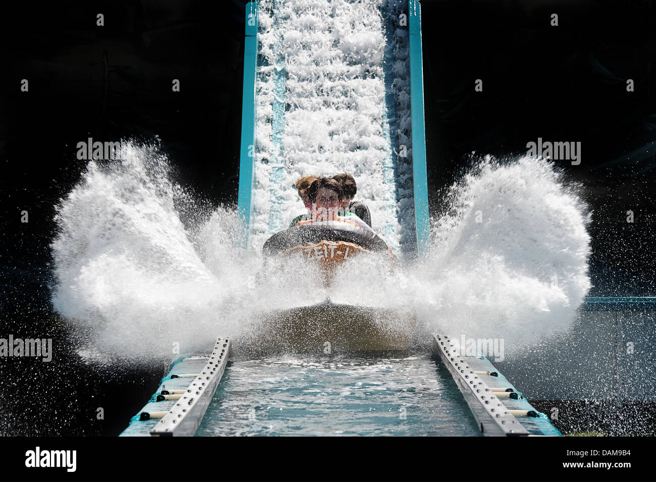 A woman rides a wild water ride at amusement park Geiselwind in ...