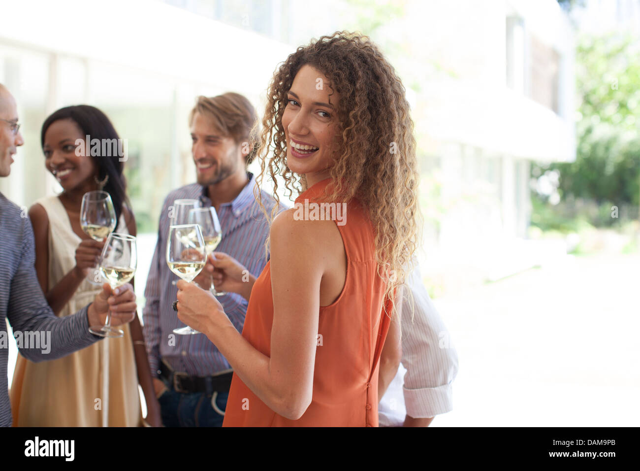 Woman smiling at party Stock Photo - Alamy