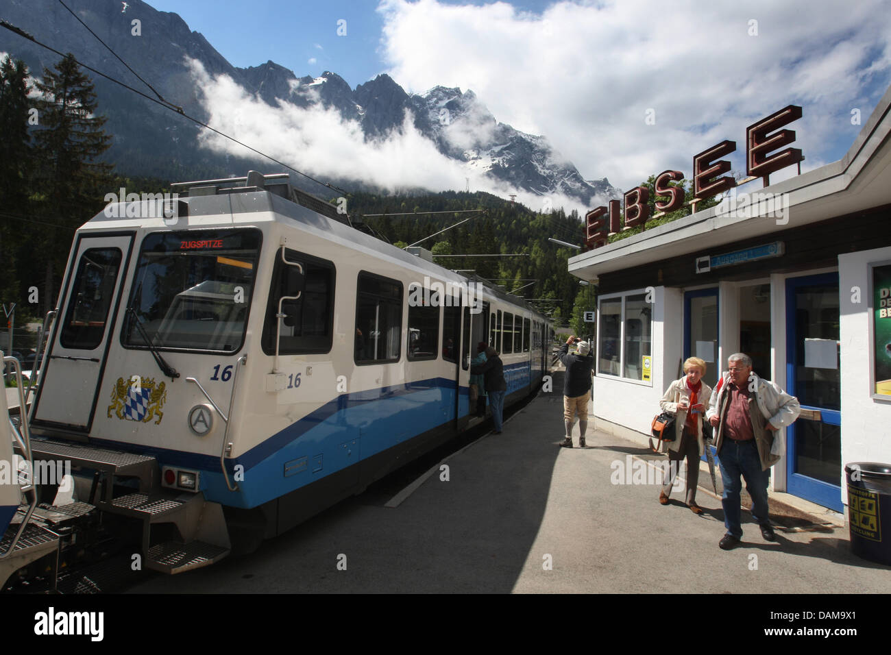 The Zugspitze Railway arrives at a train station near Grainau, Germany ...