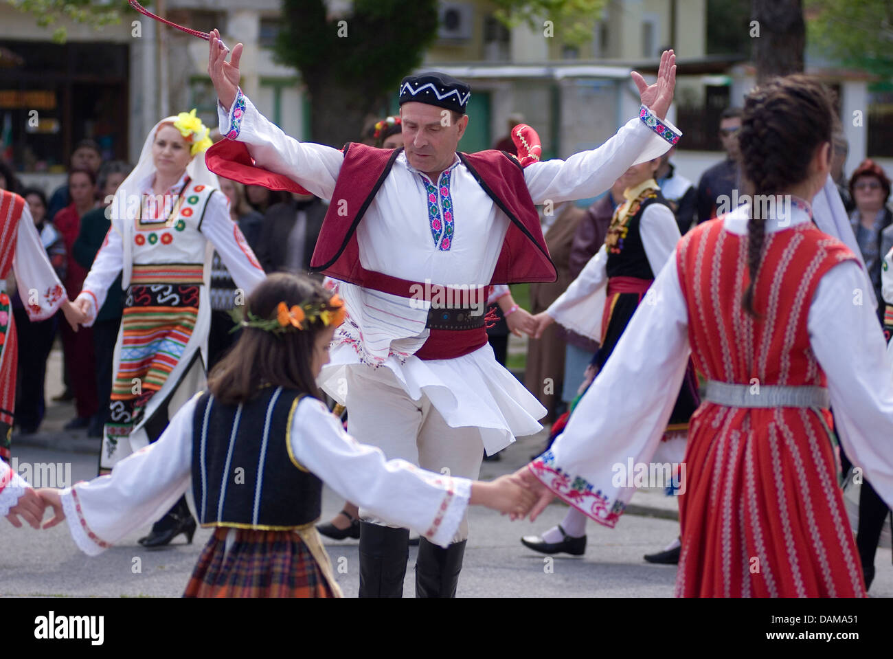 Bulgarian male dancer in traditional dress dances in the center ring of ...