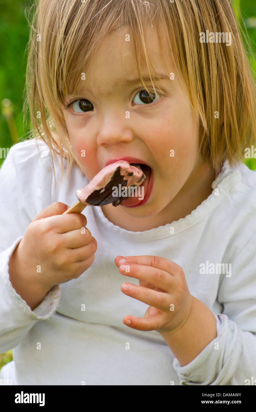 Germany, Girl eating popsicle ice cream, close up Stock Photo - Alamy