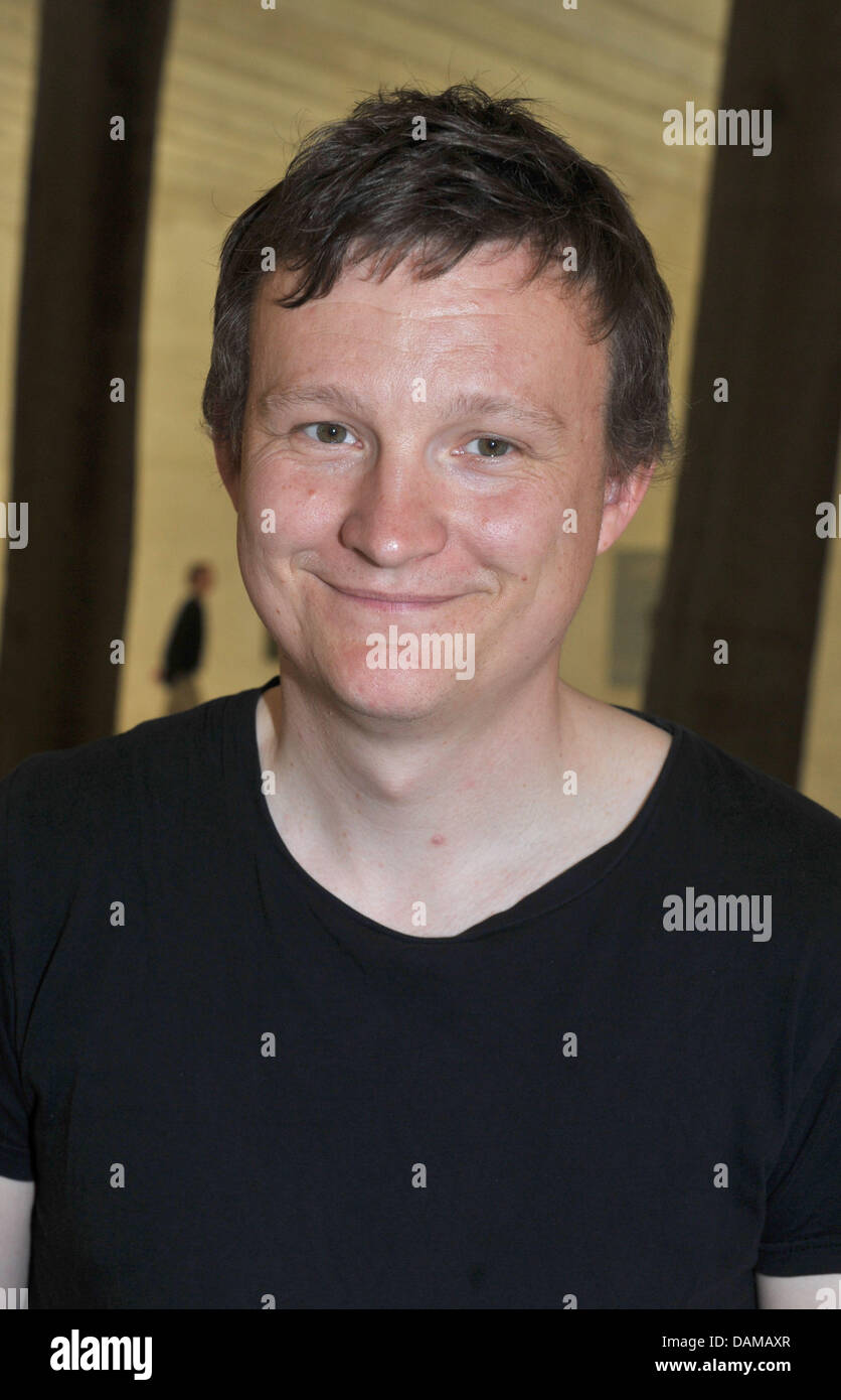 Swedish artist Andreas Eriksson poses in front of one of his works at ...