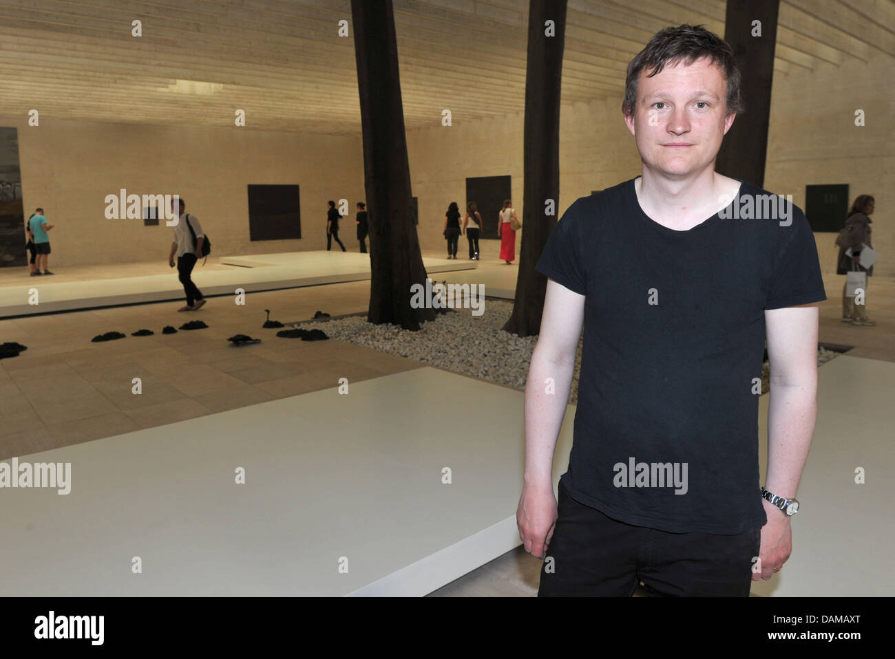 Swedish artist Andreas Eriksson poses in front of one of his works at ...