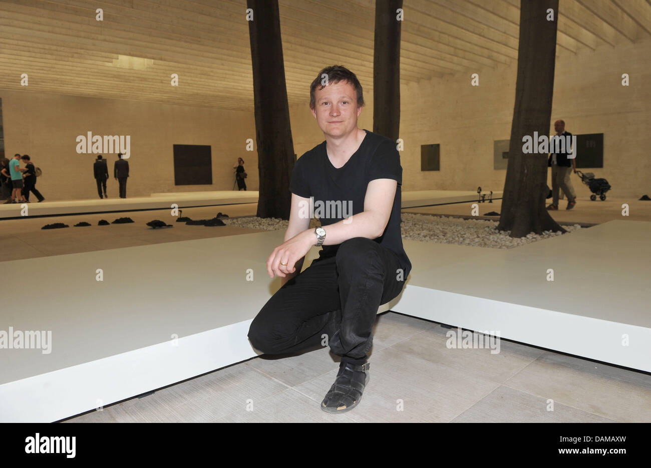 Swedish artist Andreas Eriksson poses in front of one of his works at ...