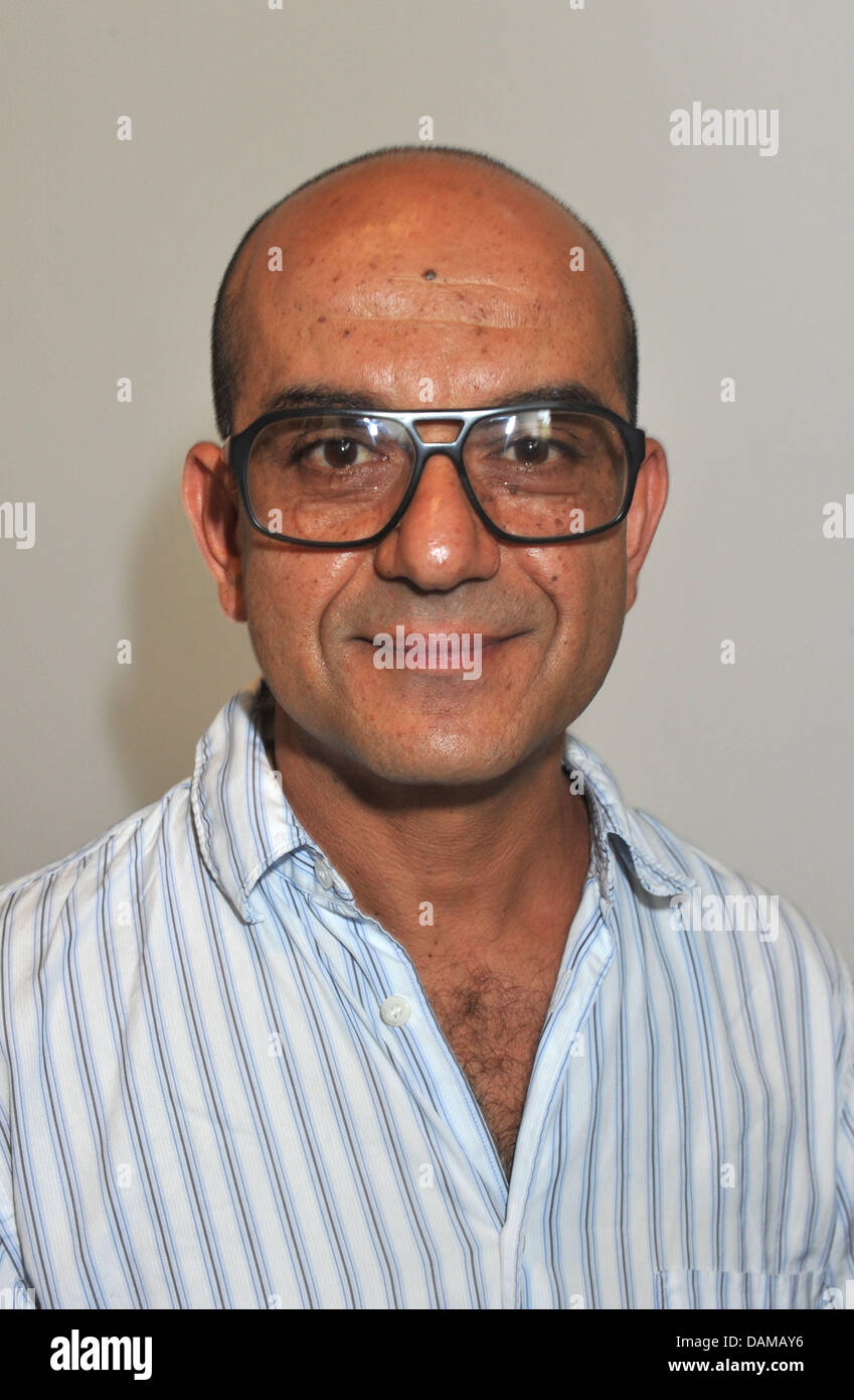 Australian artist Hany Armanious poses at the Australian pavilion on ...