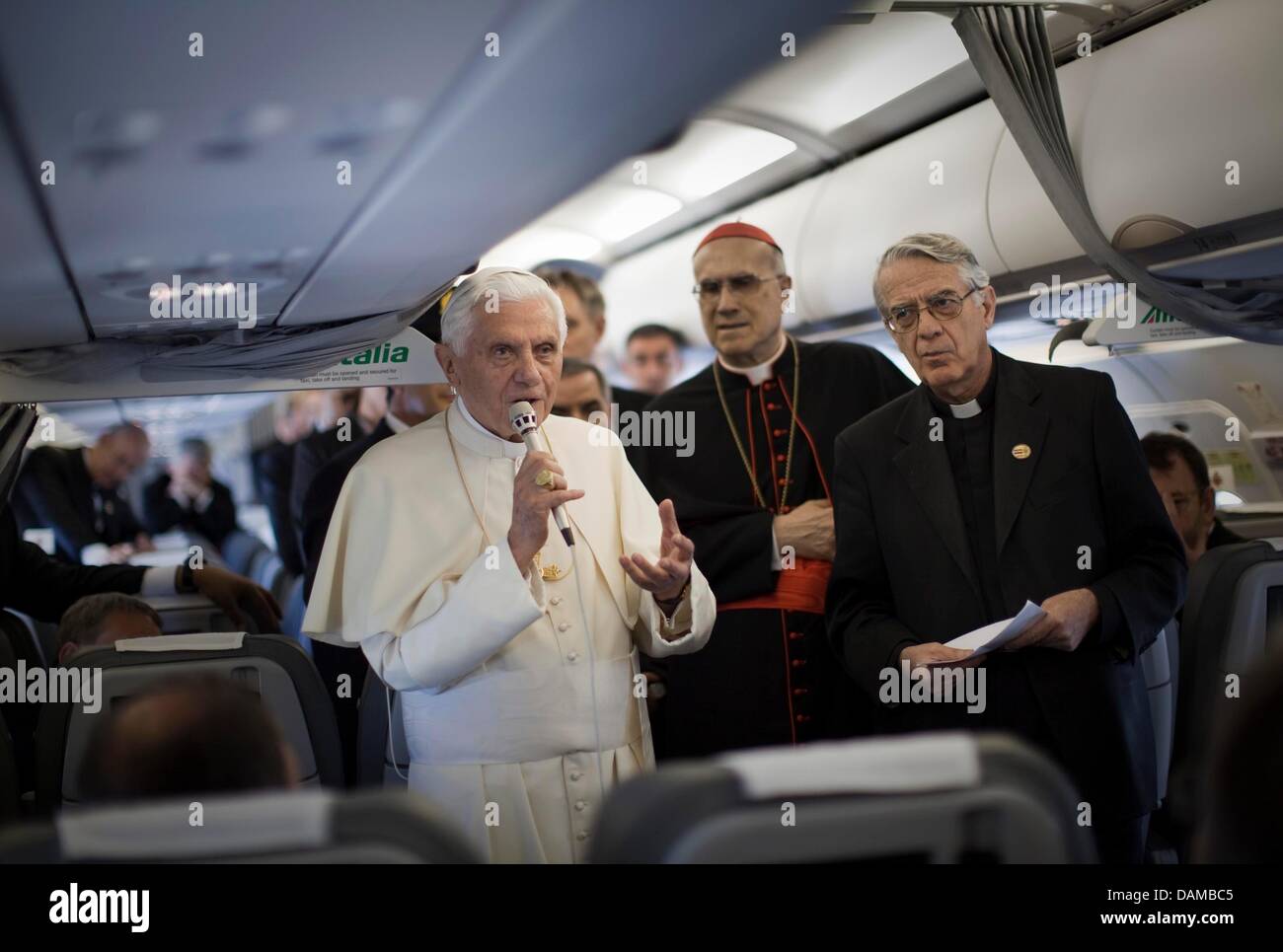 Pope Benedict XVI (L) speaks onboard the plane during his flight from ...