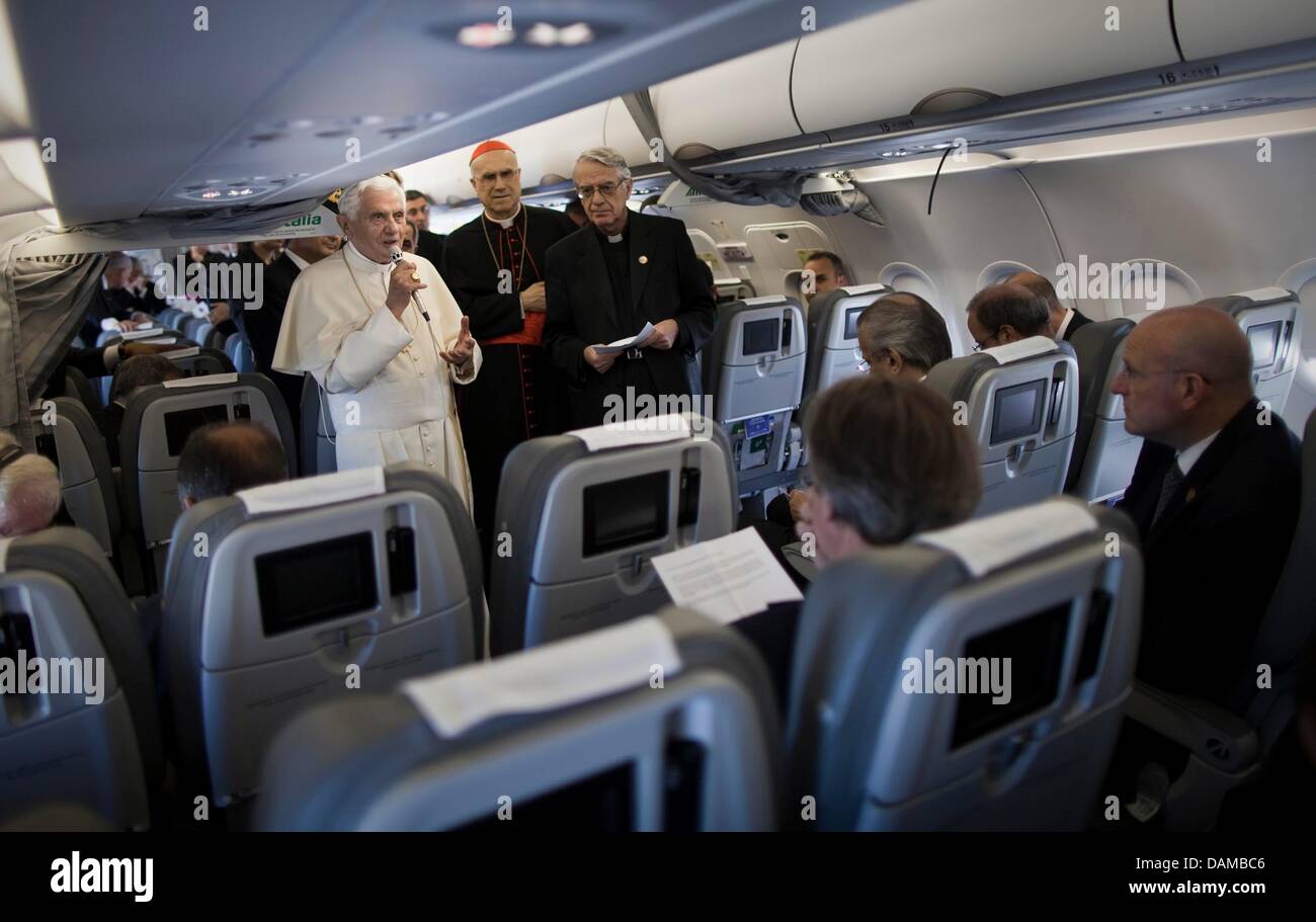 Pope Benedict XVI (L) speaks onboard the plane during his flight from ...