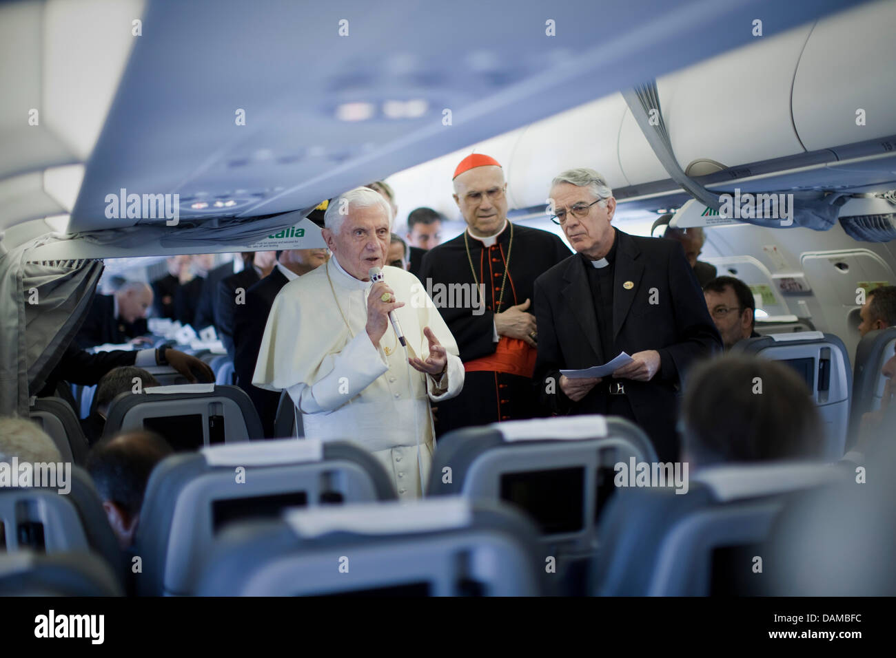 Pope Benedict XVI (L) speaks onboard the plane during his flight from ...