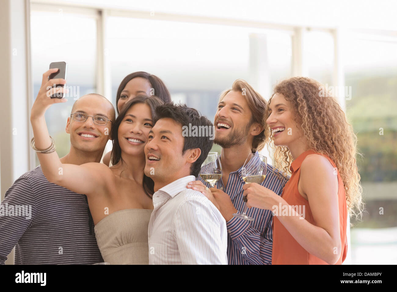 Friends taking picture together Stock Photo - Alamy