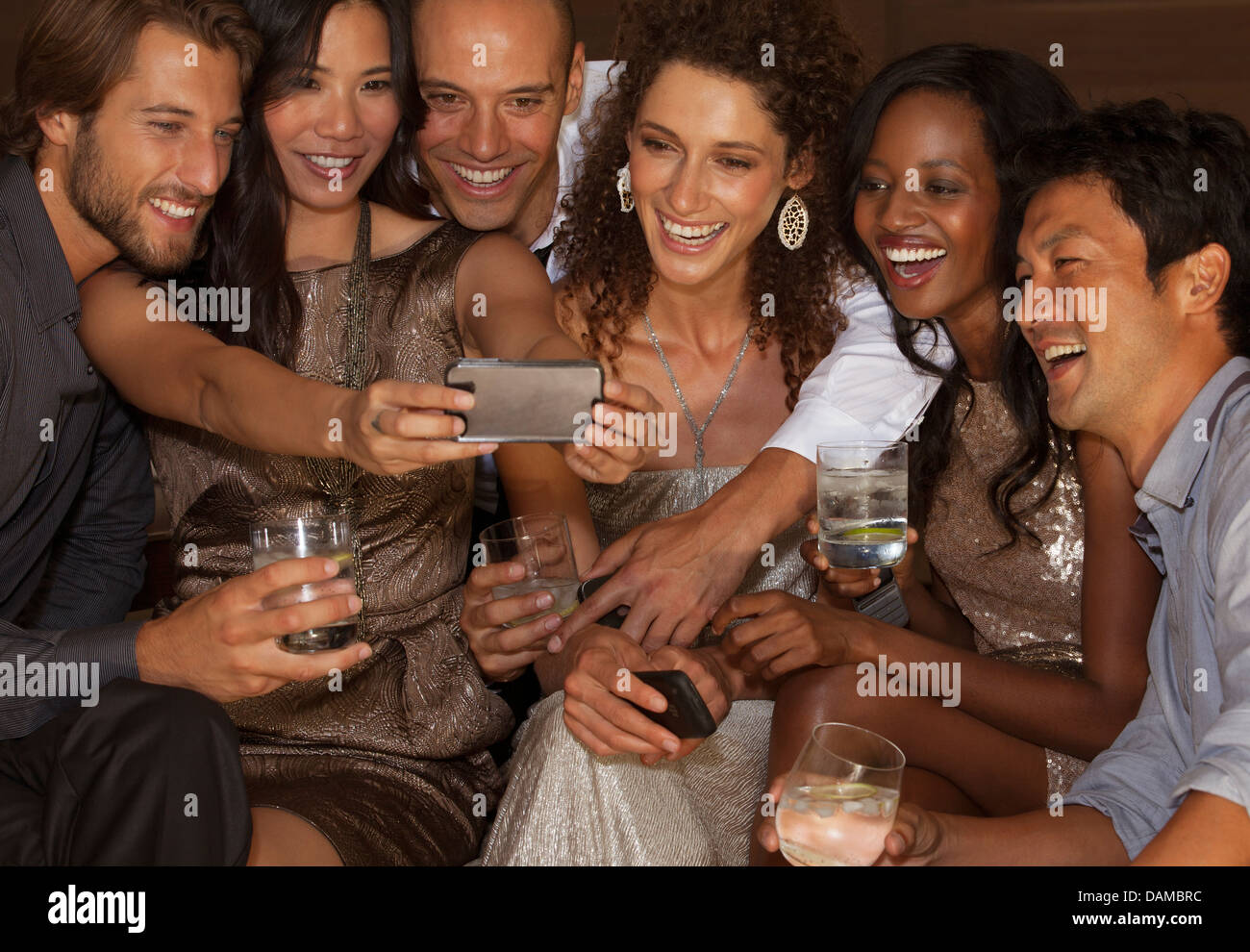 Friends taking picture together Stock Photo - Alamy