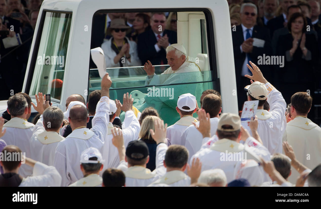 Pope Benedict XVI is driven through the crowd in his Popemobile prior ...