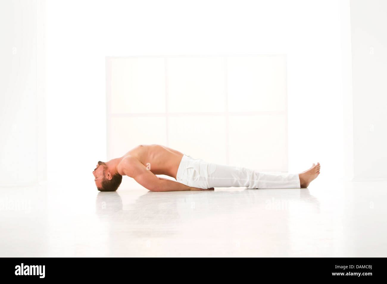 Mature man exercising fish pose Stock Photo - Alamy