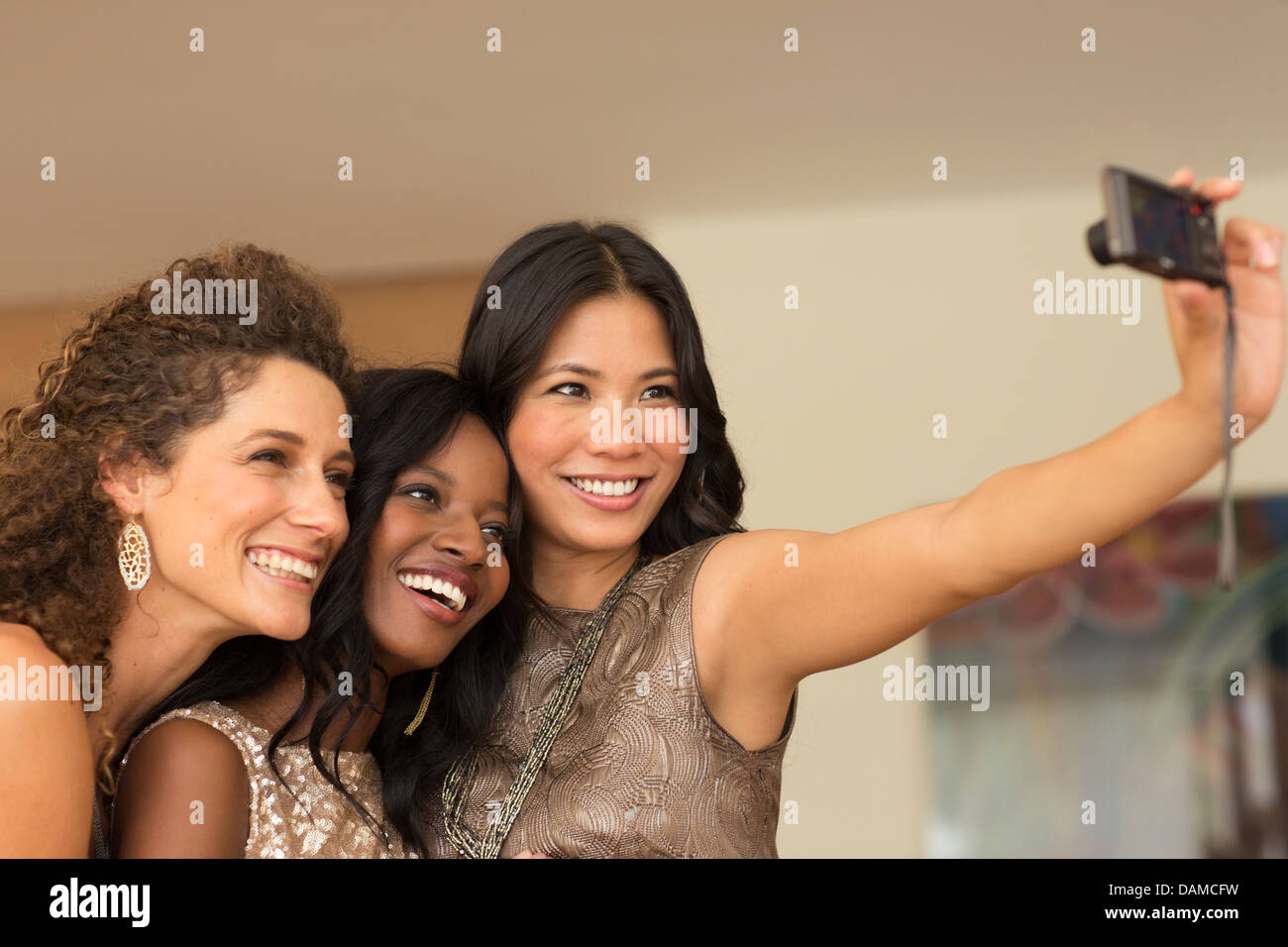 Women taking picture together indoors Stock Photo - Alamy
