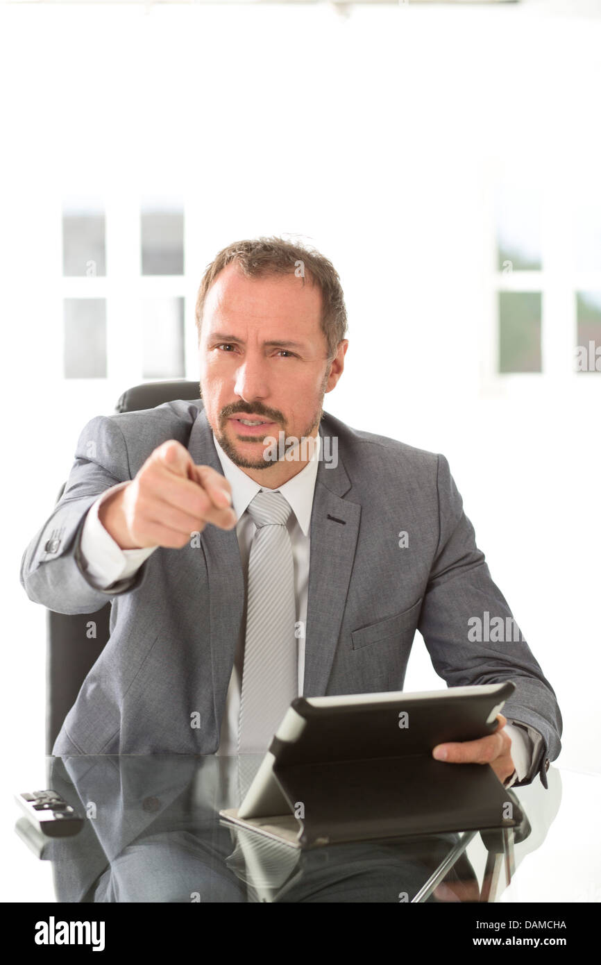 Germany, Portrait of angry businessman pointing Stock Photo - Alamy