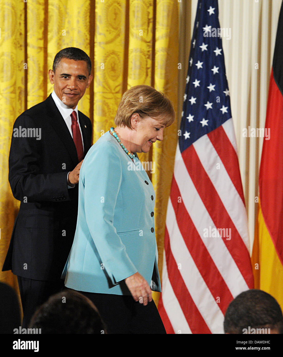 US President Barack Obama and German Chancellor Angela Merkel give a ...