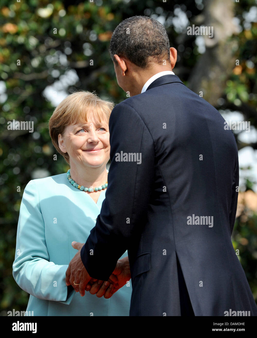 US President Barack Obama receives German Chancellor Angela Merkel with ...