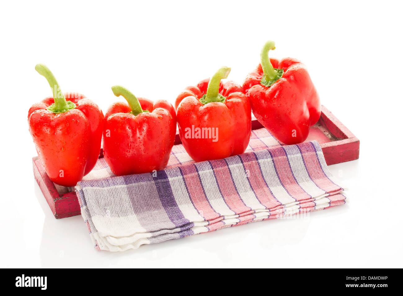 Red bell peppers on wooden tray, close up Stock Photo - Alamy